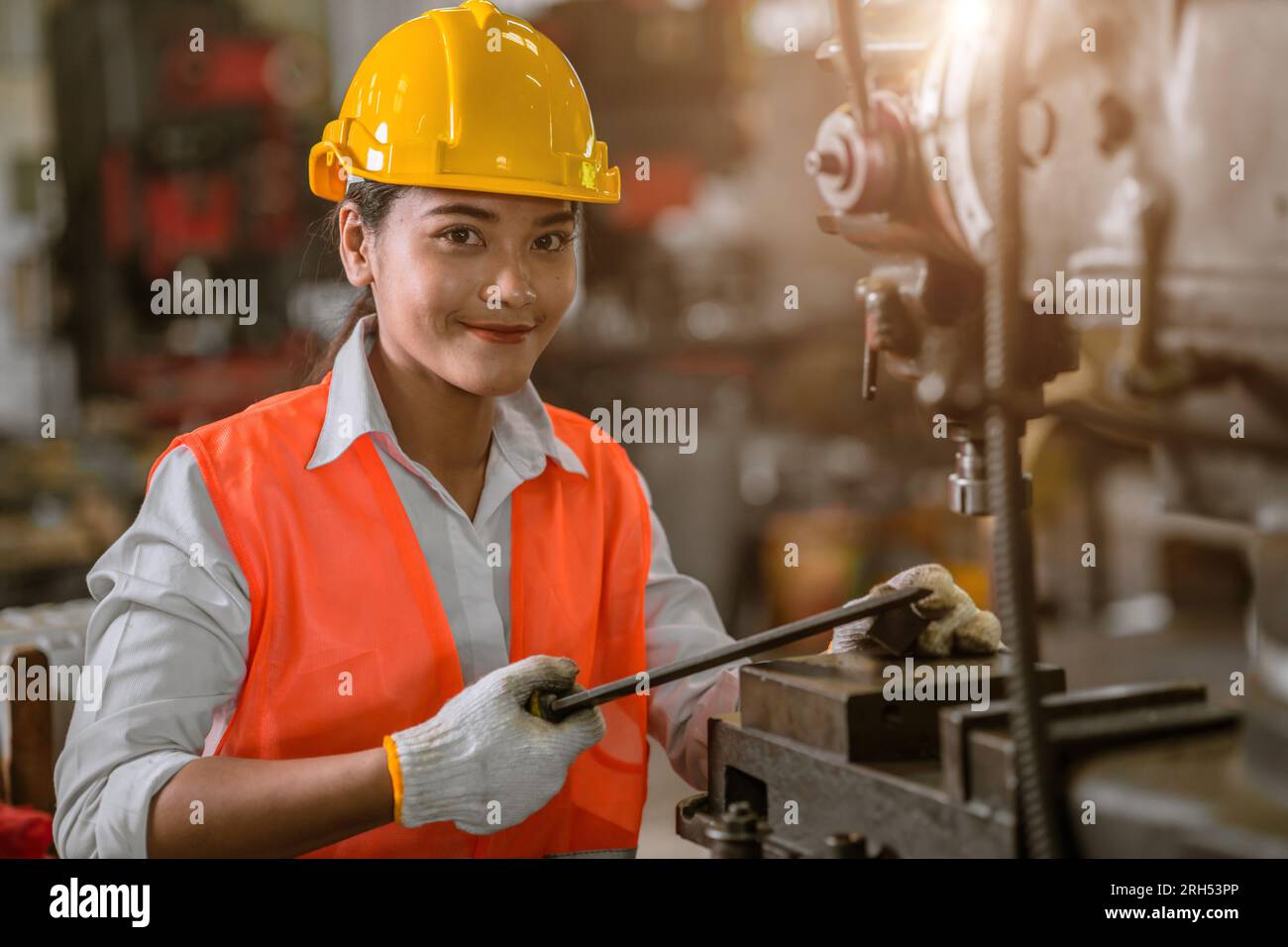 happy young asian woman worker with heavy metal machine lathe milling ...