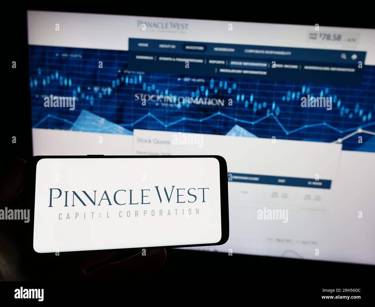 Person holding mobile phone with logo of US company Pinnacle West ...