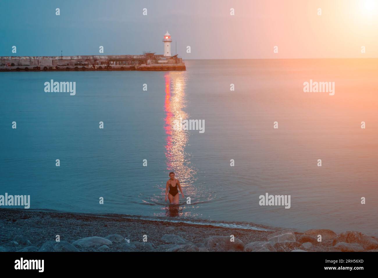 Woman The full moon rises to the lighthouse, the lunar path along the ...