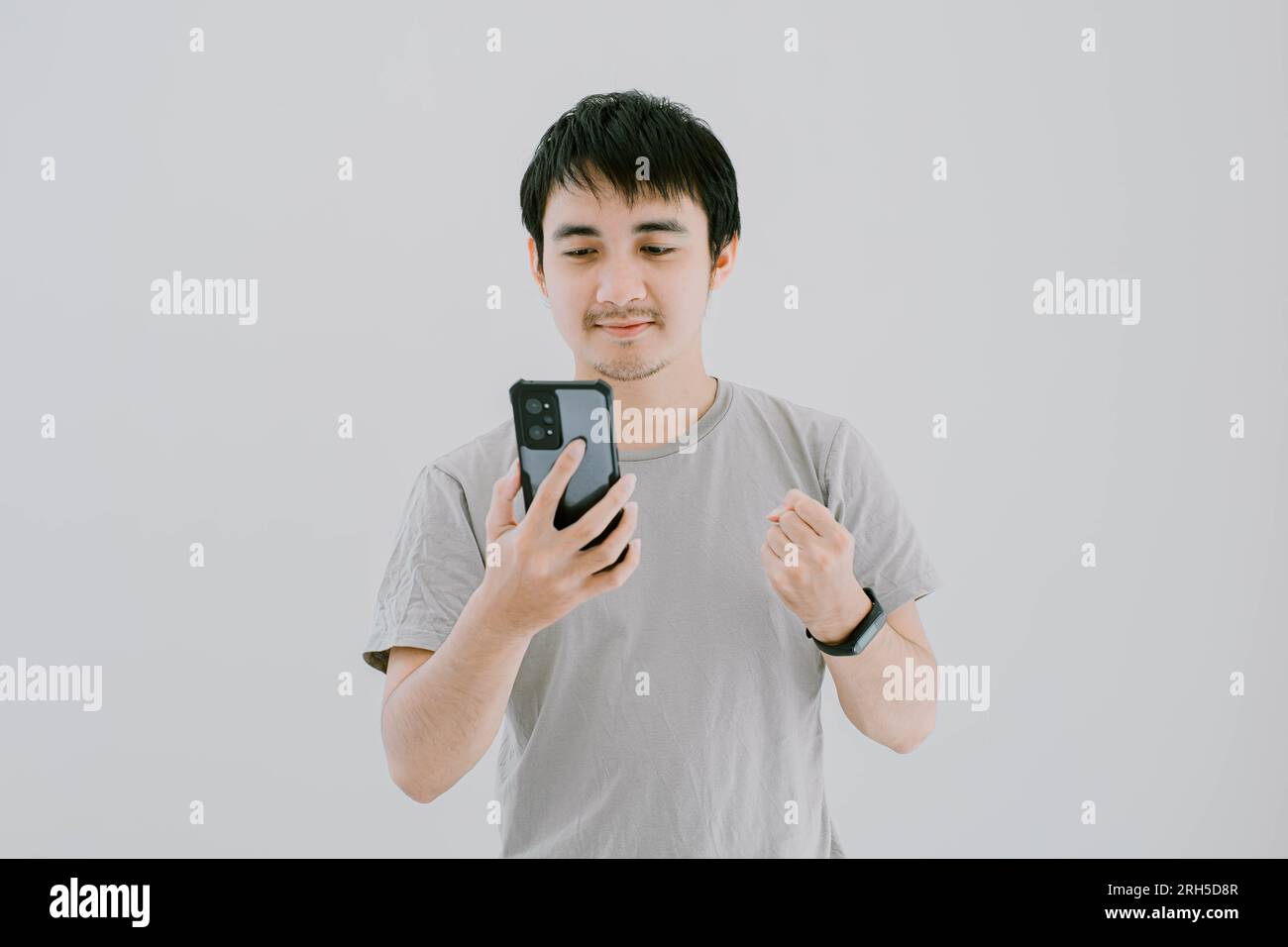 Selective focus shot of young Asian man wearing sage green casual T ...