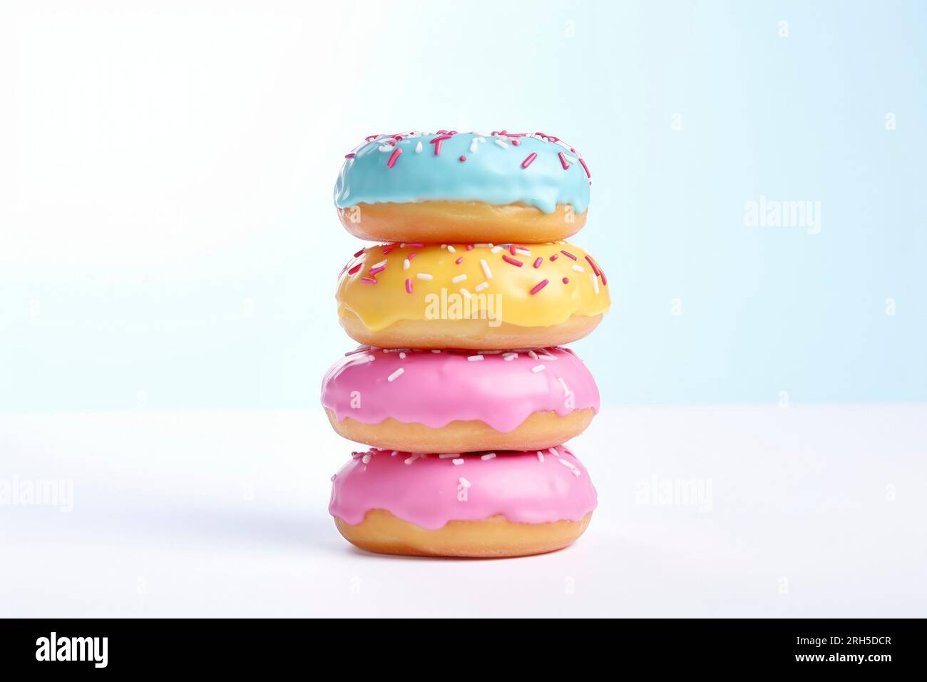Delightful stack of vibrant donuts perfectly contrasted against a white ...
