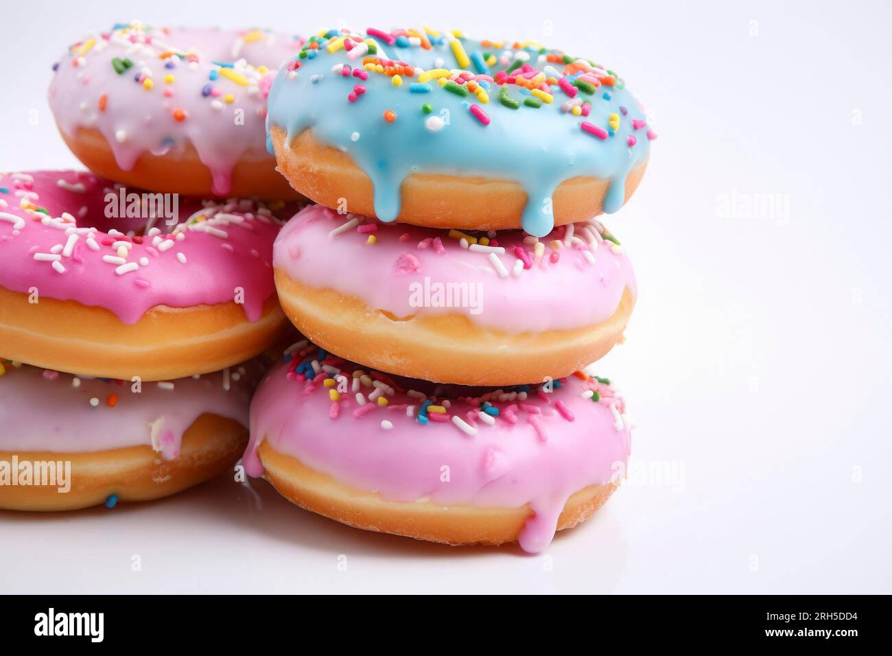 Colorful donuts showcased in a delicious array against a pristine white ...