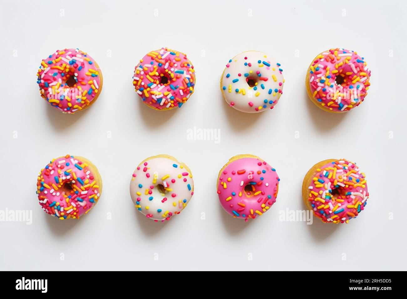 Colorful donuts showcased in a delicious array against a pristine white ...