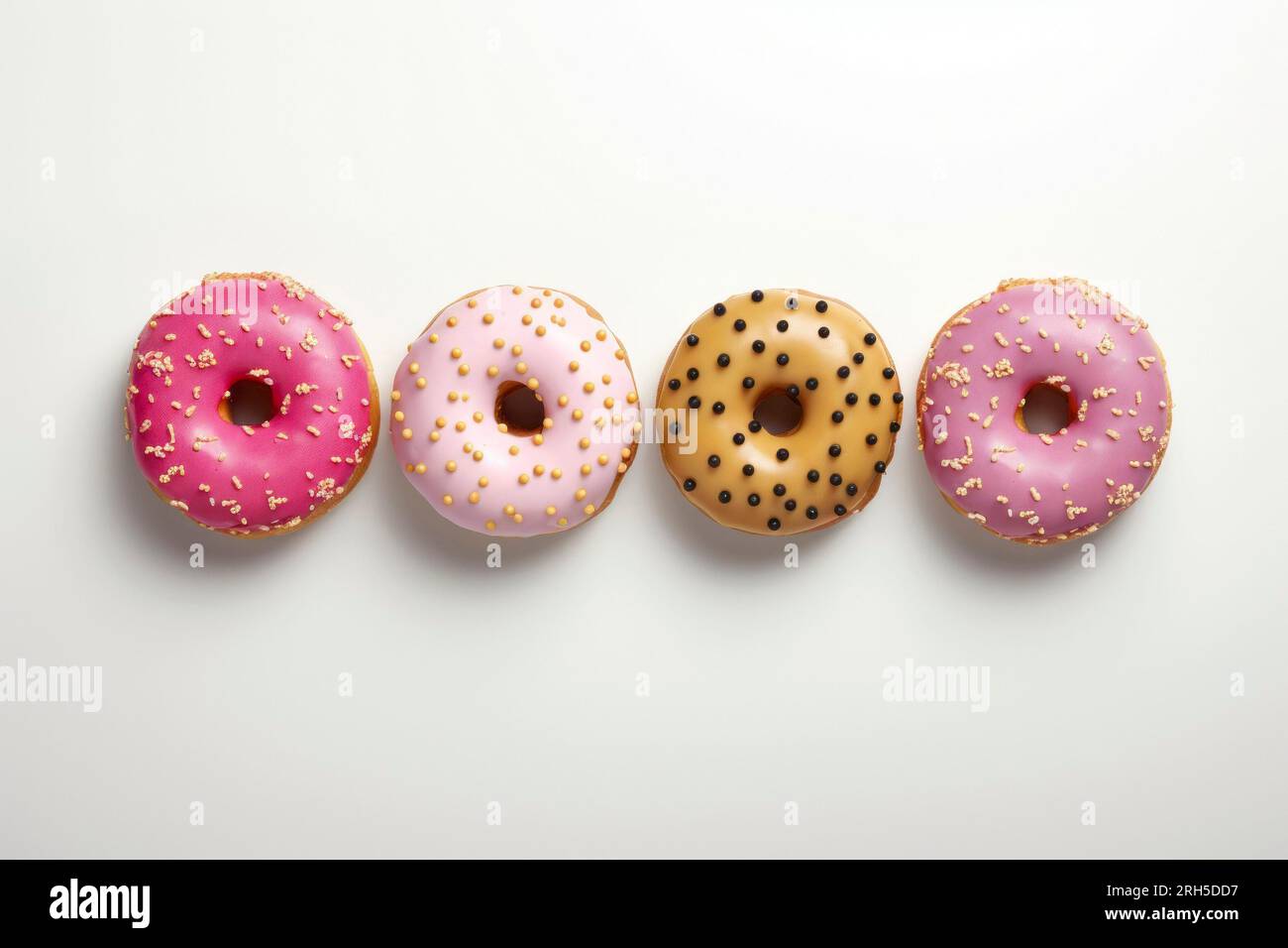 Colorful donuts showcased in a delicious array against a pristine white ...