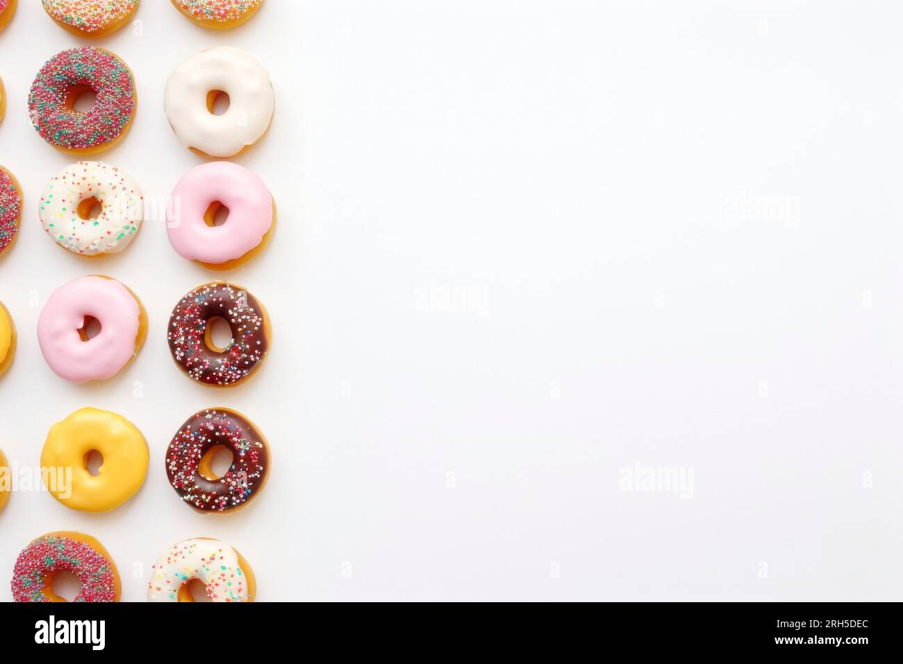 Colorful donuts showcased in a delicious array against a pristine white ...