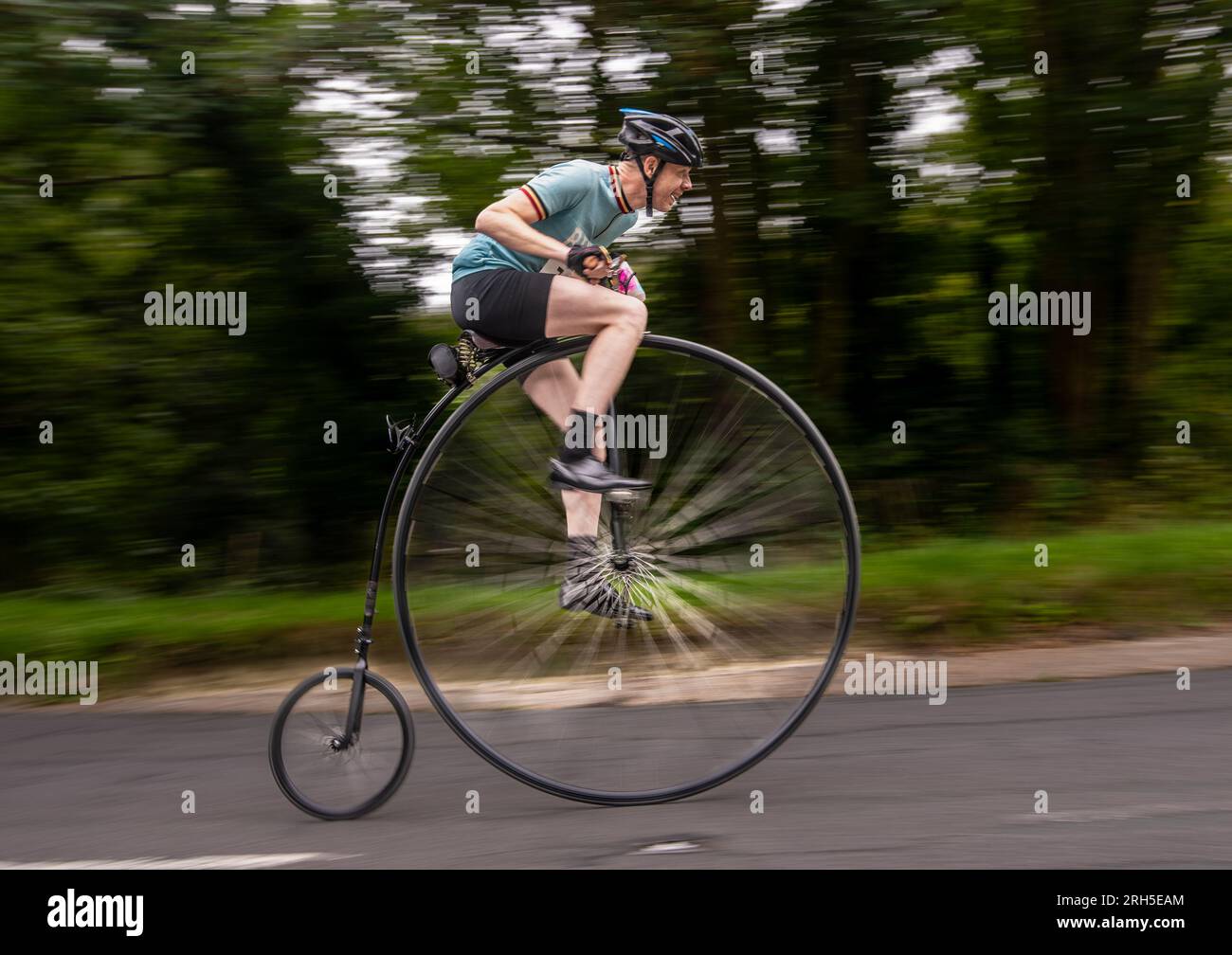Competitors take part in a penny farthing time trial hill hi-res stock ...