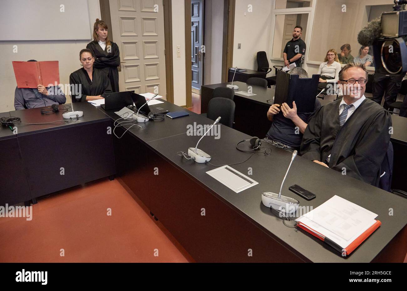 14 August 2023, Hamburg: The two defendants sit in the courtroom before ...