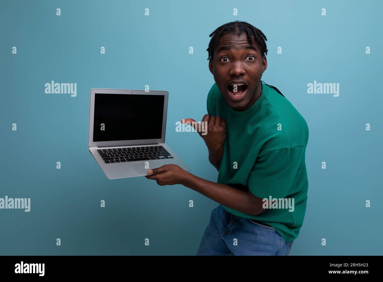 charismatic consultant demonstrates laptop screen on studio background ...