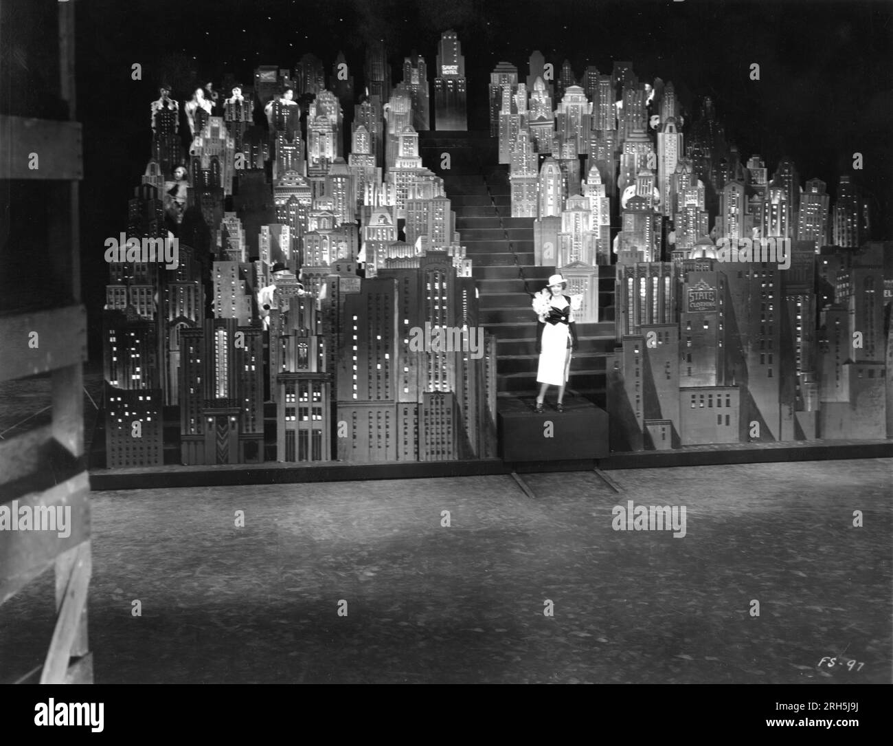 RUBY KEELER on set candid with Chorus Girls behind city building fronts ...