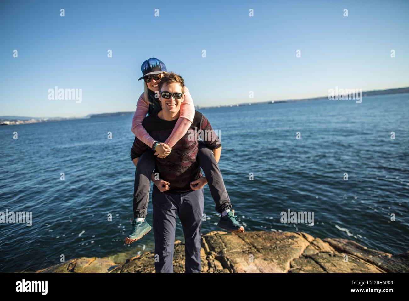playful couple at the beach, piggy back ride Stock Photo - Alamy