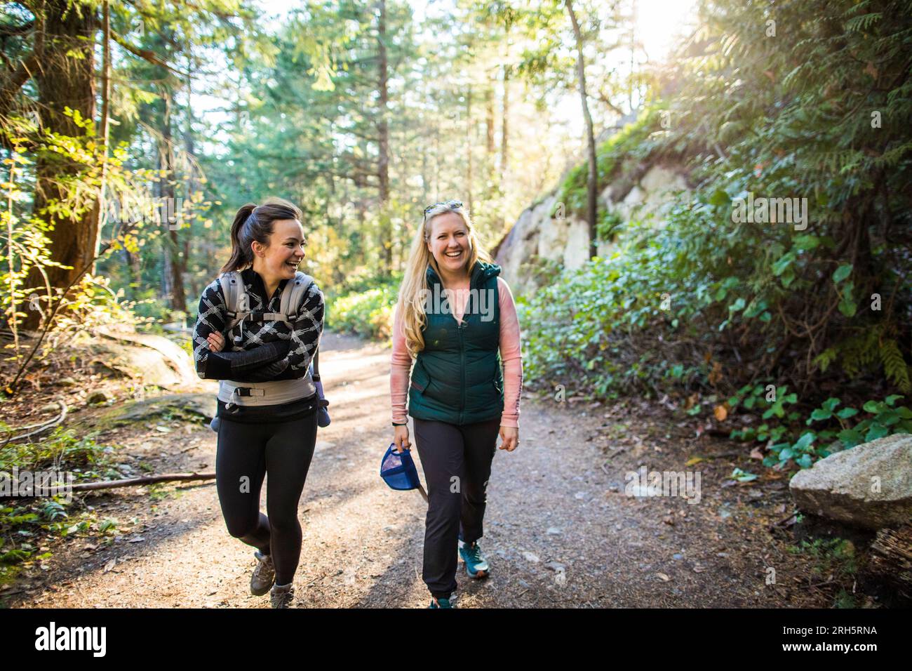 Friends, moms hike, mile and laugh together on hiking trail Stock Photo ...