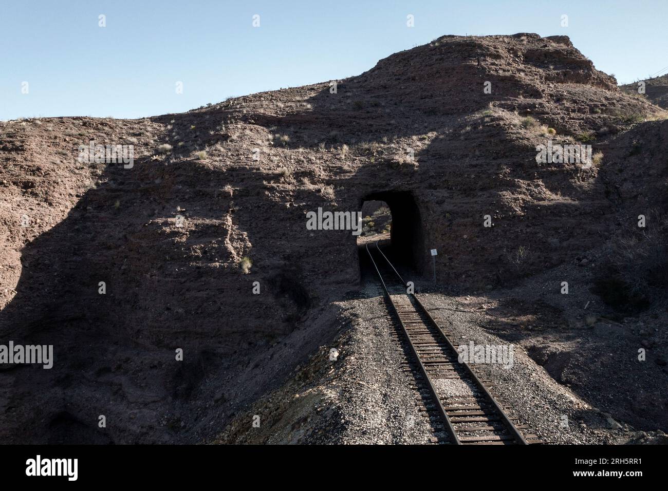 Train tracks going through tunnel opening Stock Photo - Alamy