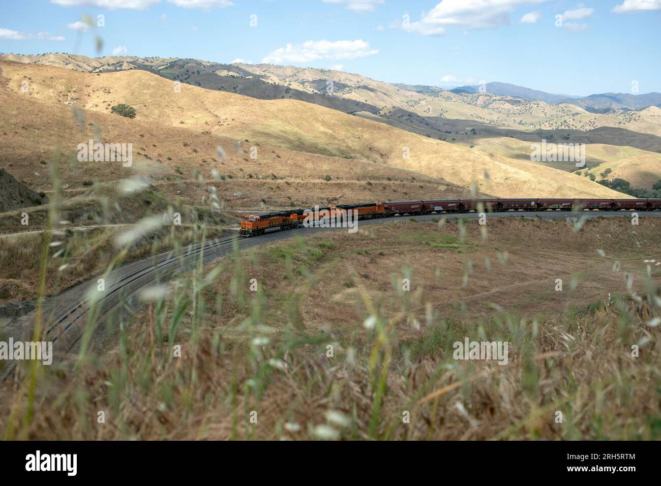 A grain train rounds bend in overlooking view Stock Photo - Alamy