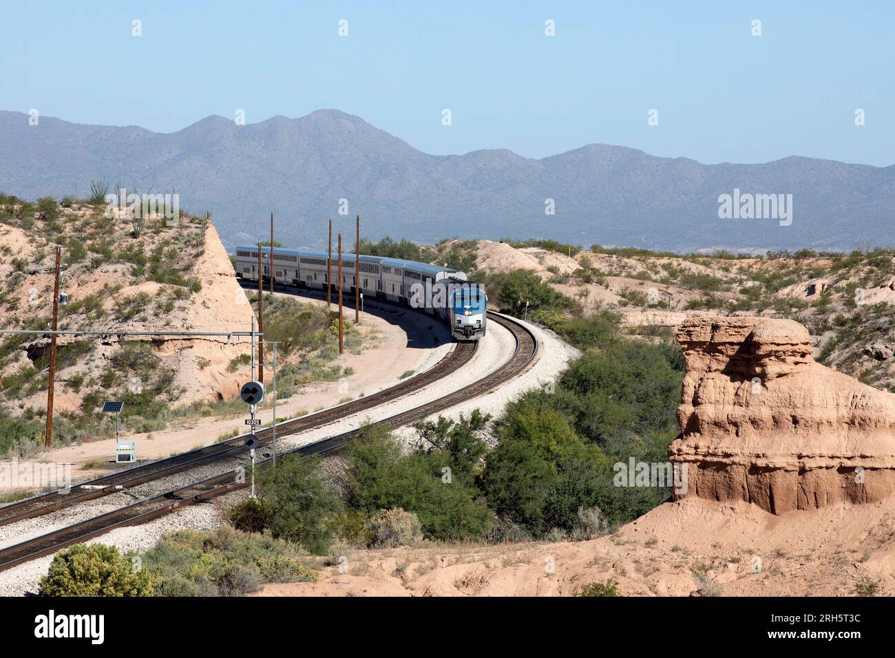 Amtrak train rounds bend in desert mountain landscape Stock Photo - Alamy