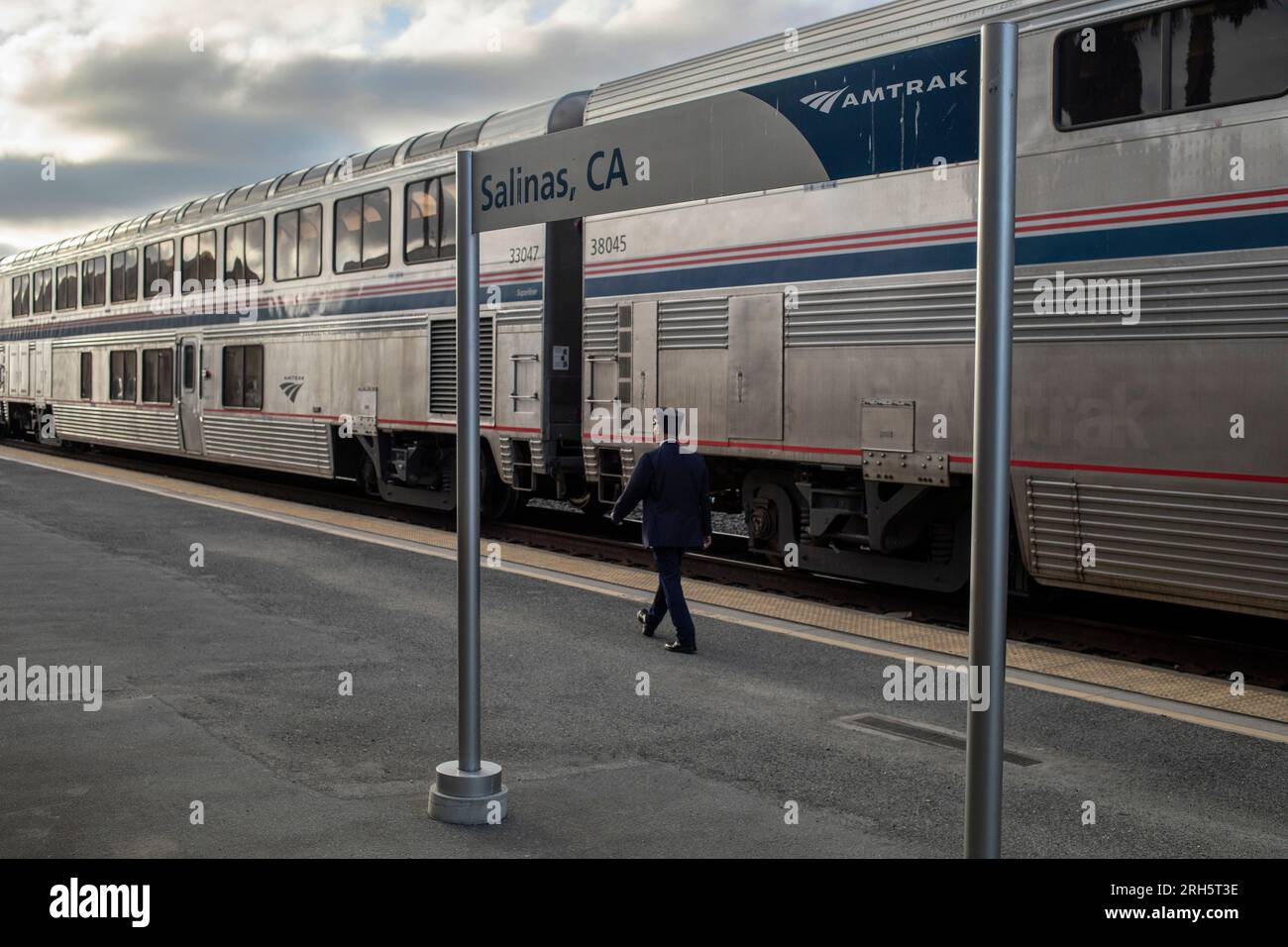A conductor walks along side a passenger train at Salinas Stock Photo ...