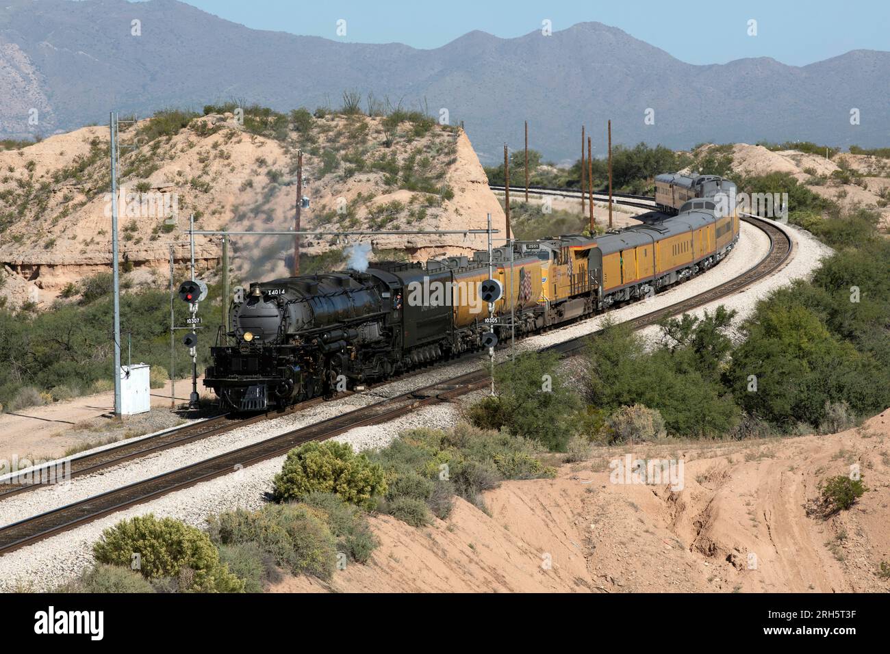 A modern steam engine passenger train in desert landscape Stock Photo ...