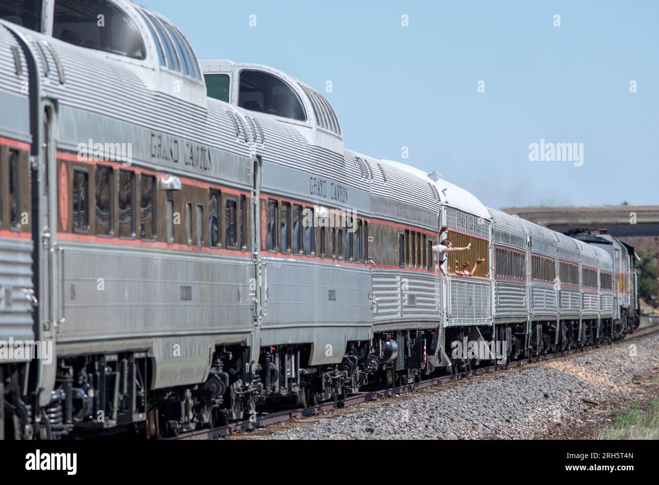 People wave from passenger train cars to people out of view Stock Photo ...