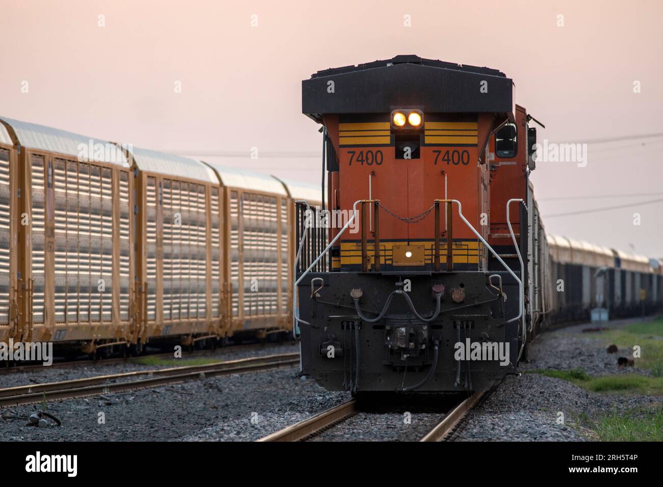 Passing trains at sunset in muted daylight Stock Photo - Alamy