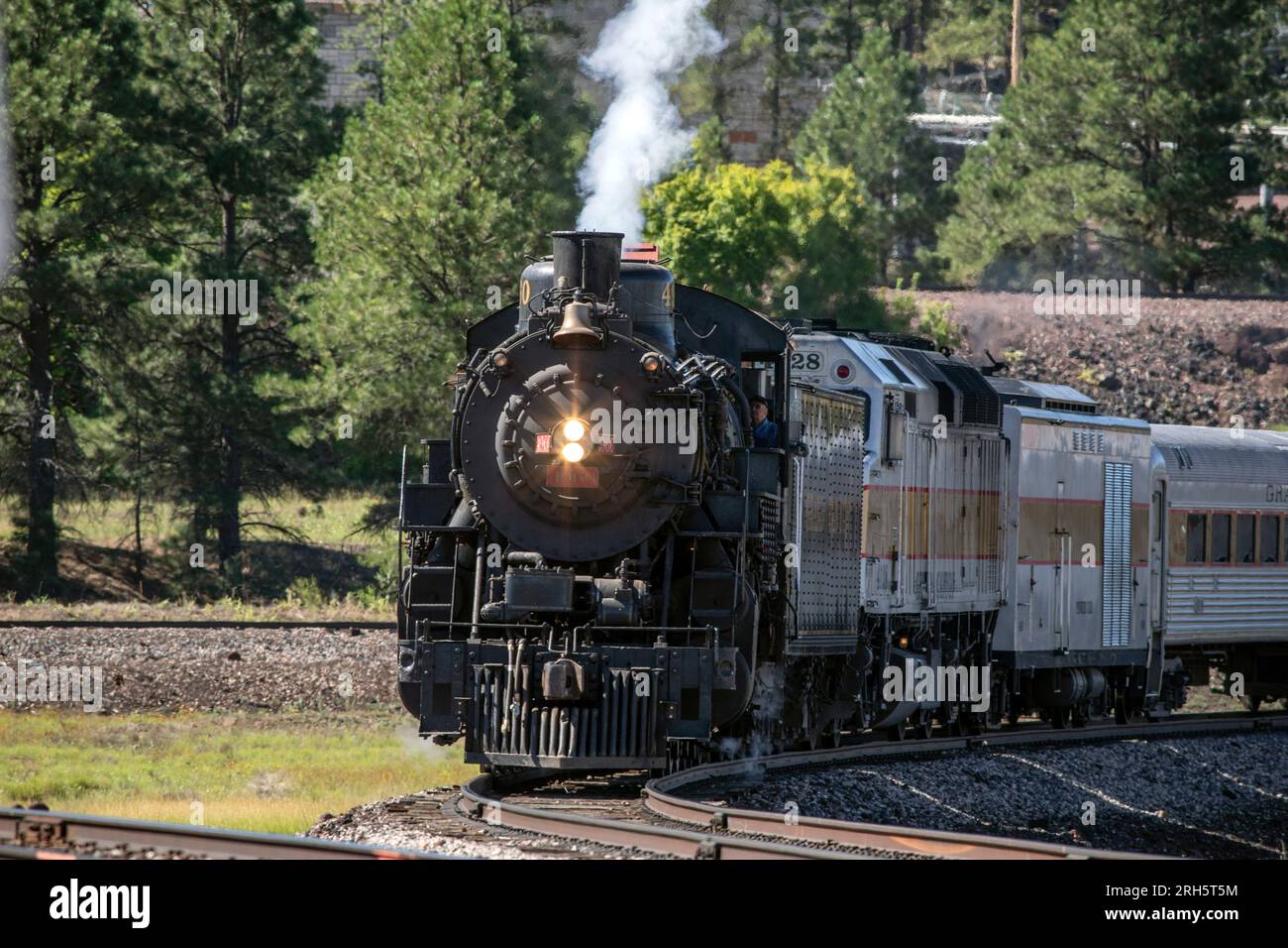 Steam passenger train approaching long lens shot Stock Photo - Alamy