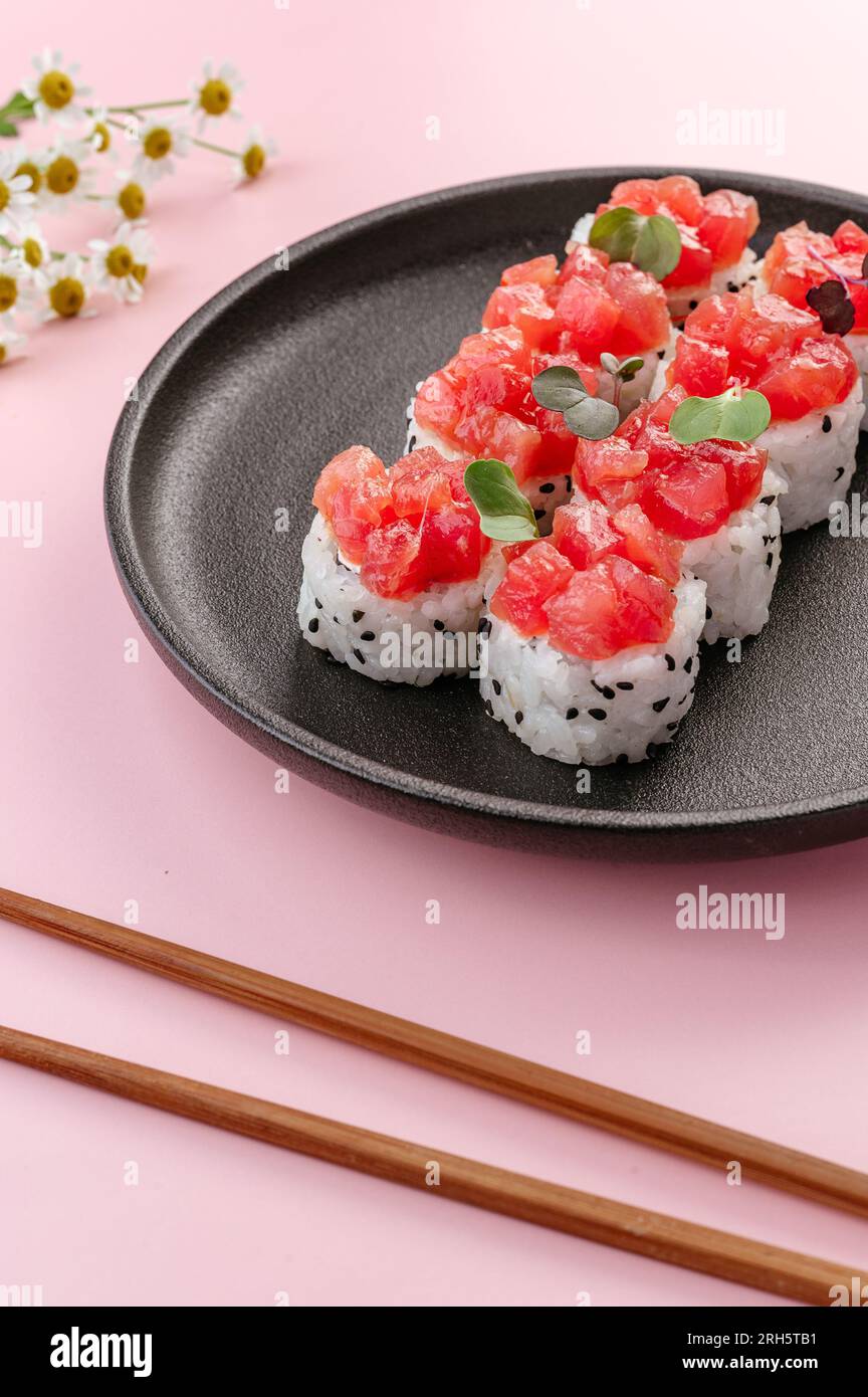 japanese sushi rolls with a cap on a plate and bamboo sticks nea Stock ...