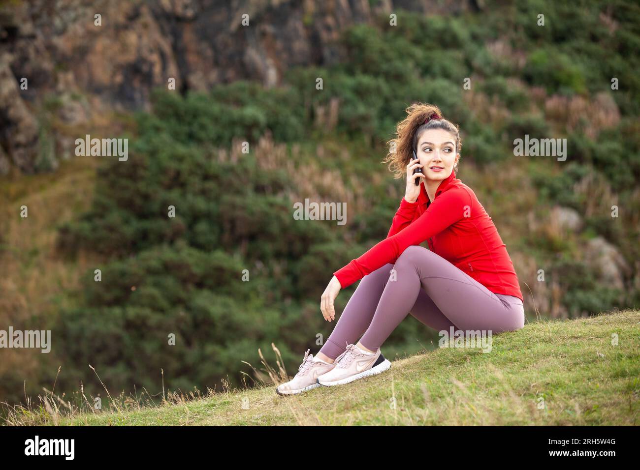 Young woman wearing leggings sitting hi-res stock photography and ...