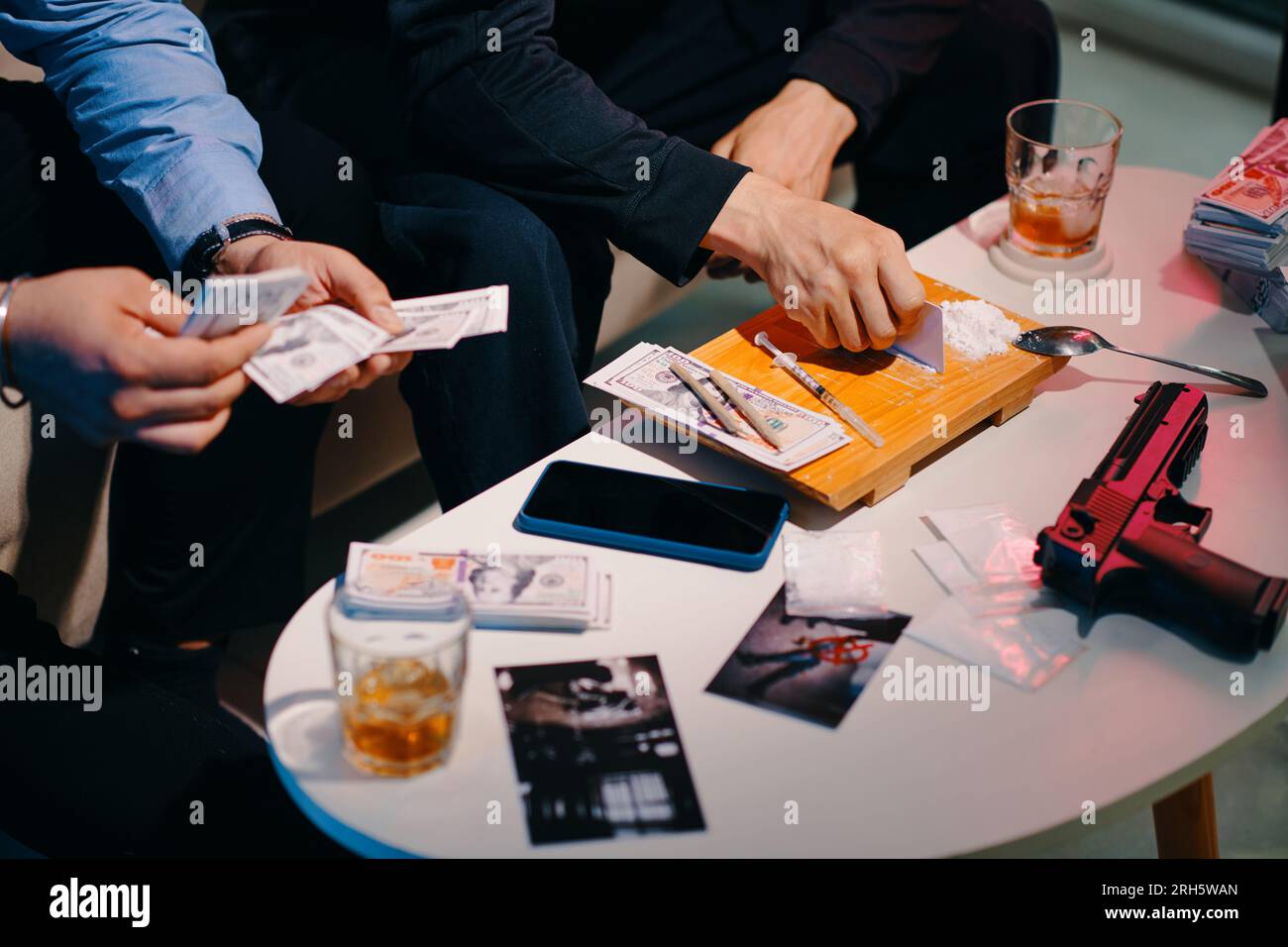 Hands of cartel kingpin counting money when drug dealer snorting line ...