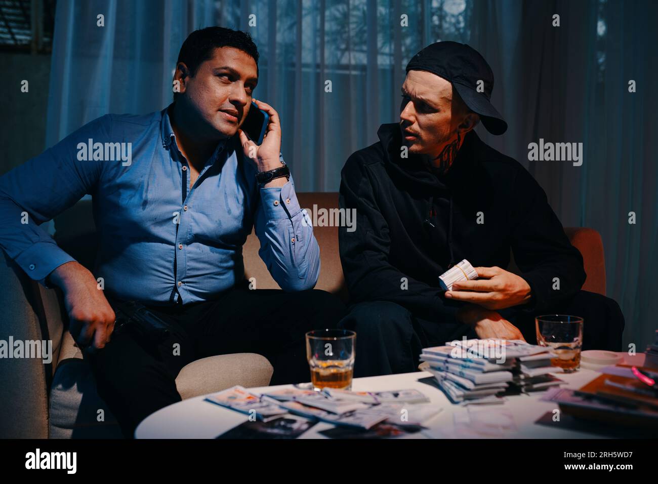 Criminal making phone call when counting money with drug dealer Stock ...