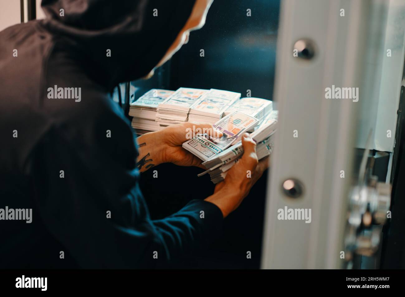 Thief stealing money from safe hi-res stock photography and images - Alamy