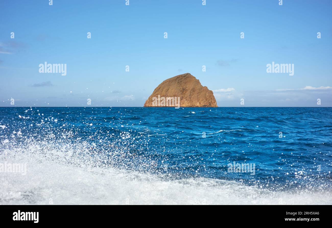 Desert volcanic island seen from the water, Galapagos National Park ...