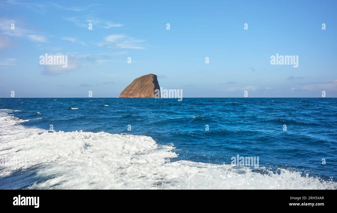 Desert volcanic island seen from the water, Galapagos National Park ...
