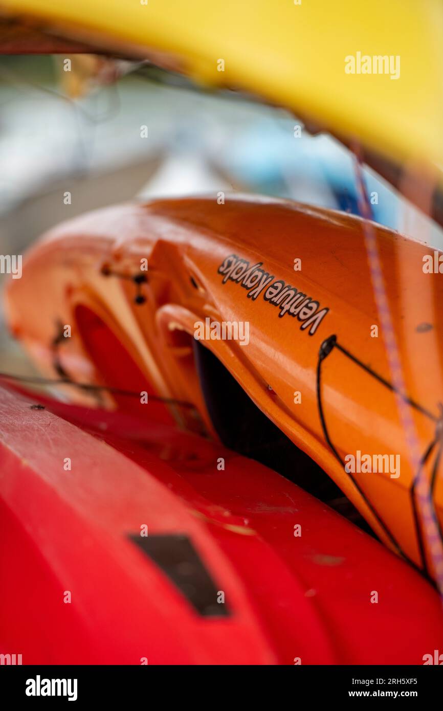 abstract image of colourful canoes and kayaks on a rack Stock Photo - Alamy