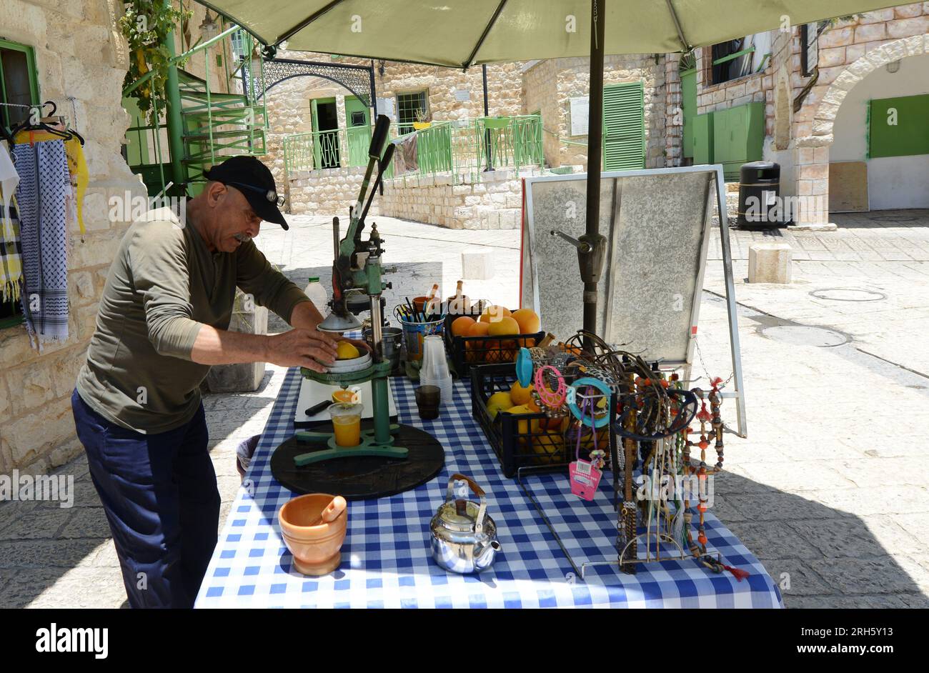 A Druz man squeezing Orange juice in a small cafe in the village of ...