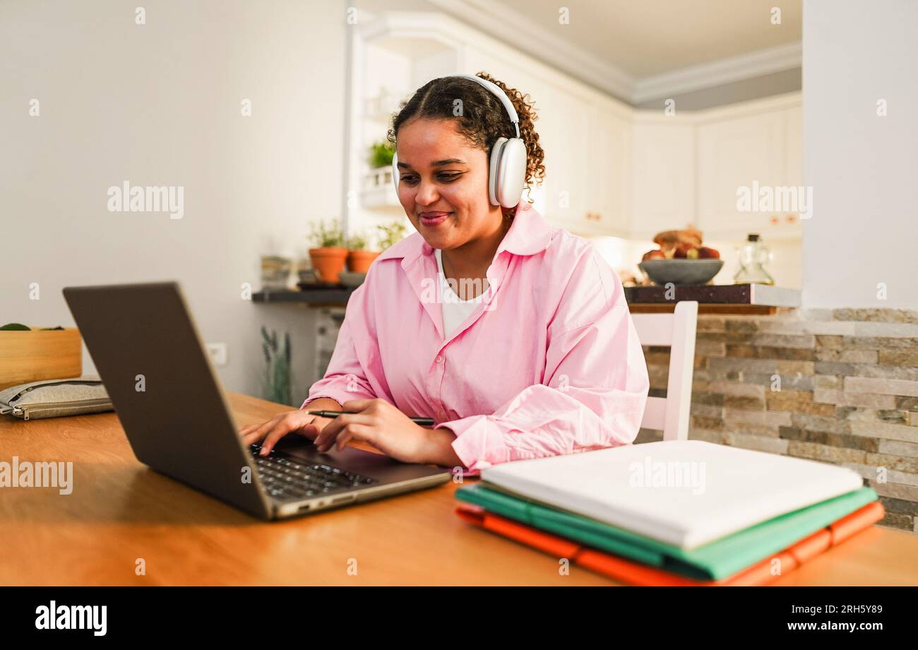 Girl using laptop computer from home while studying at college homework ...