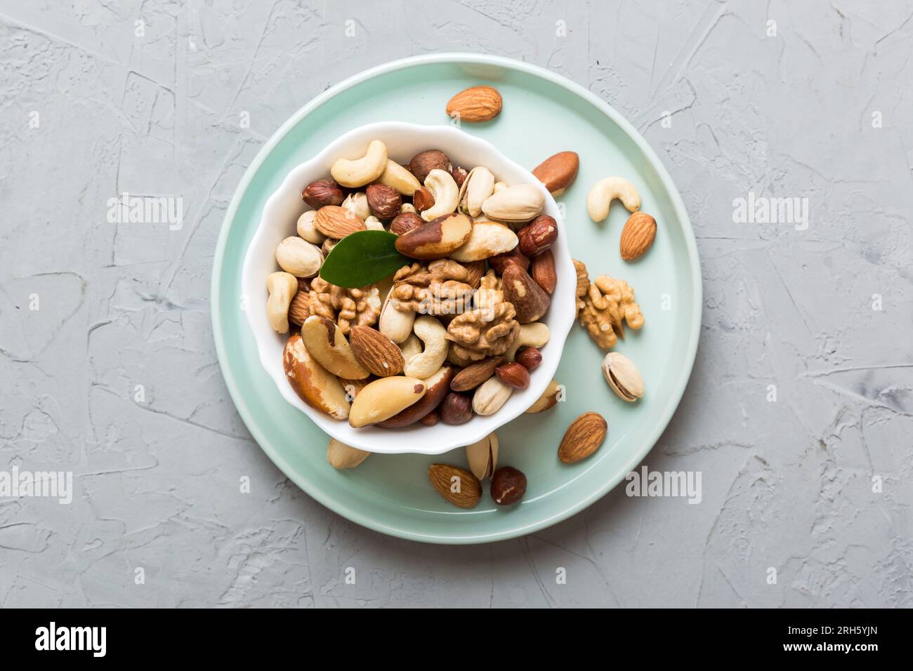 mixed nuts in bowl. Mix of various nuts on colored background ...