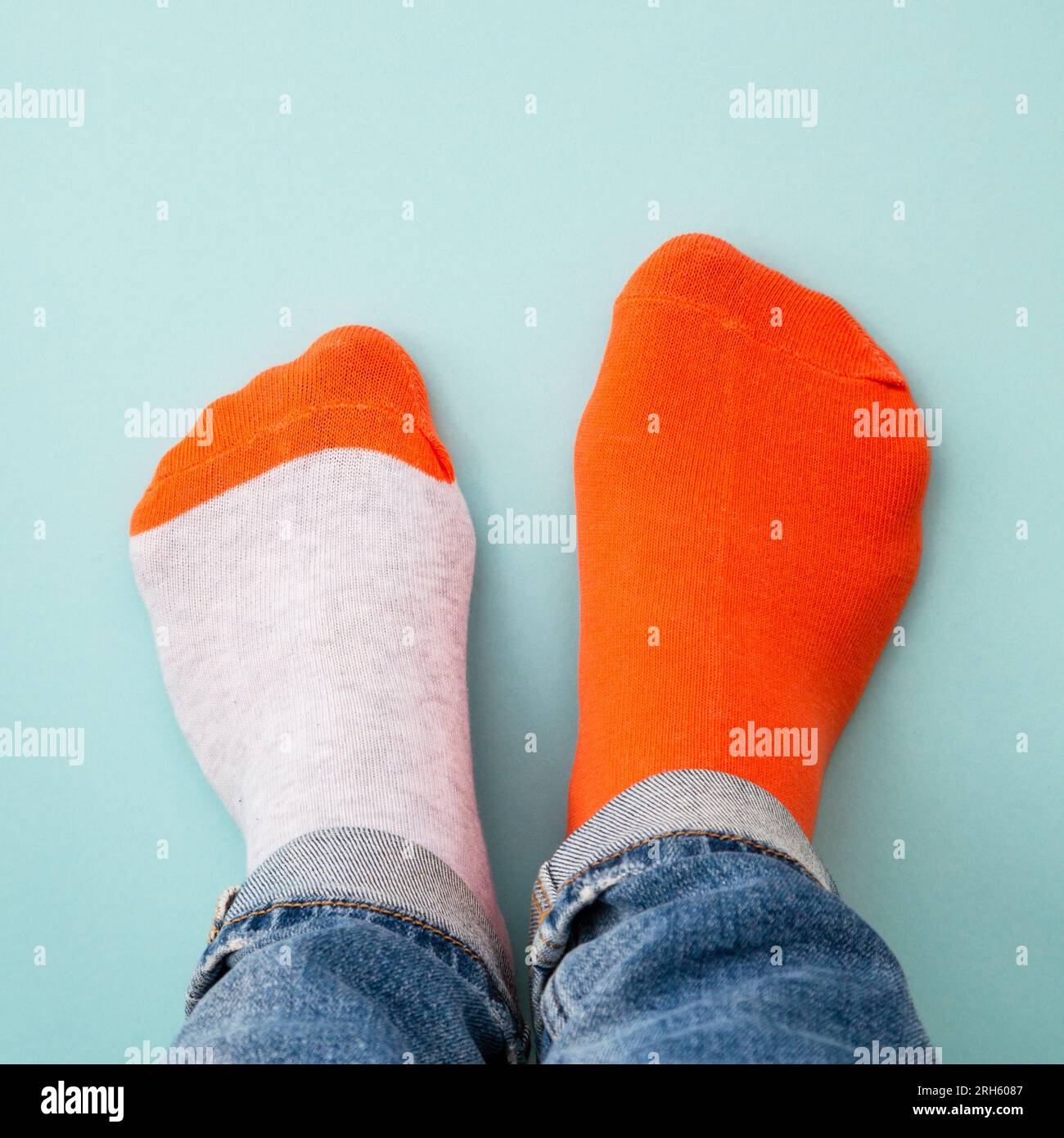 Odd socks day concept. Mismatch socks at blue Stock Photo - Alamy