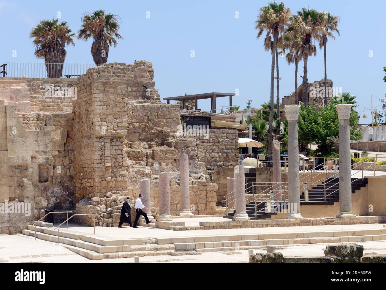 Tourist walking by the Roman ruins in the excavated ancient town of ...