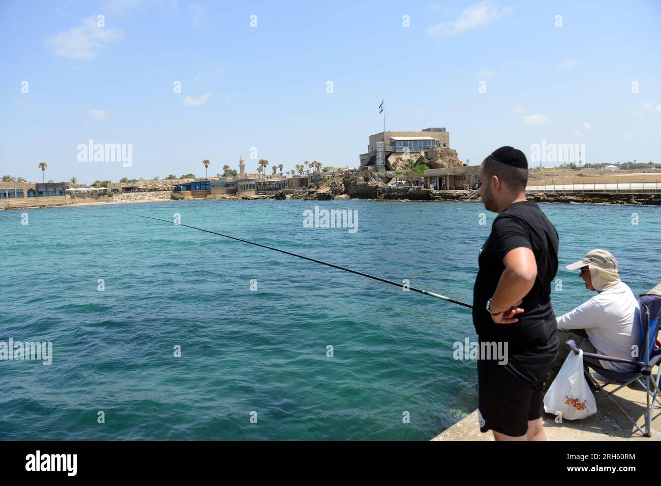 Israeli men fishing at the Caesarea Harbor in Israel Stock Photo - Alamy