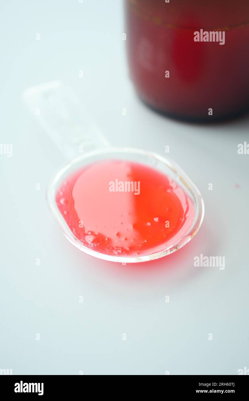 liquid medicine syrup on a plastic spoon on white background Stock ...