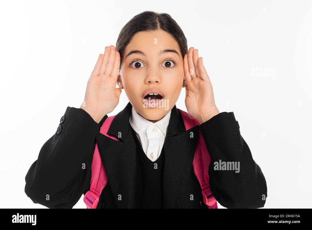 shocked schoolgirl in uniform looking at camera isolated on white ...