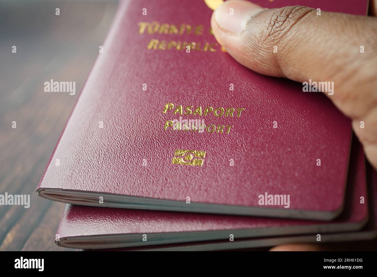 stack of red color passport on table Stock Photo - Alamy