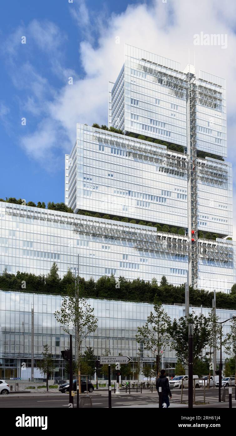 Clouds & blue sky reflected in the glazing of the hi-tech, energy ...