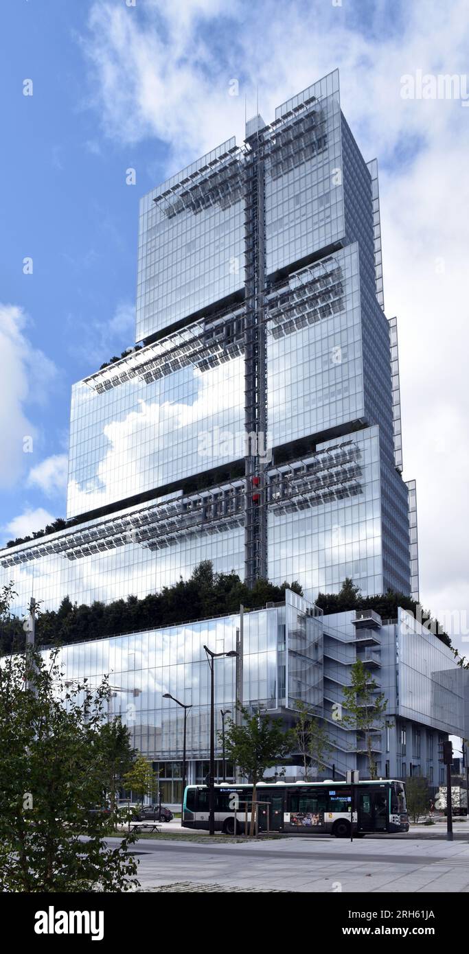 Clouds & blue sky reflected in the glazing of the hi-tech, energy ...