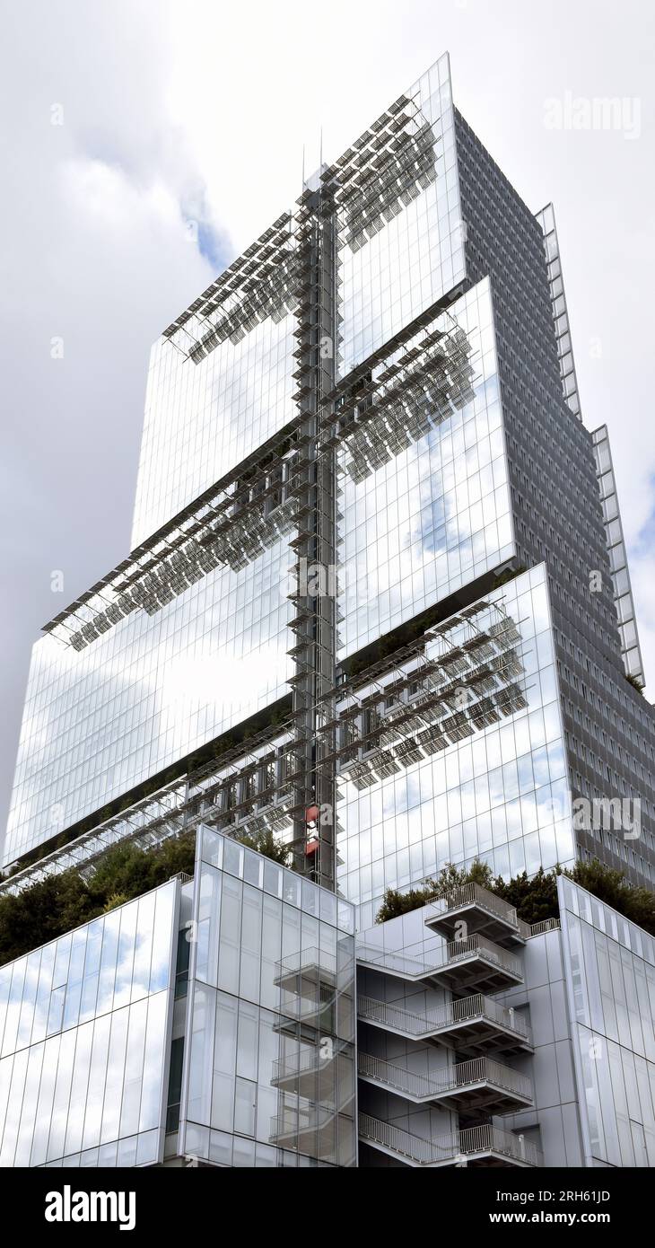 Clouds & blue sky reflected in the glazing of the hi-tech, energy ...