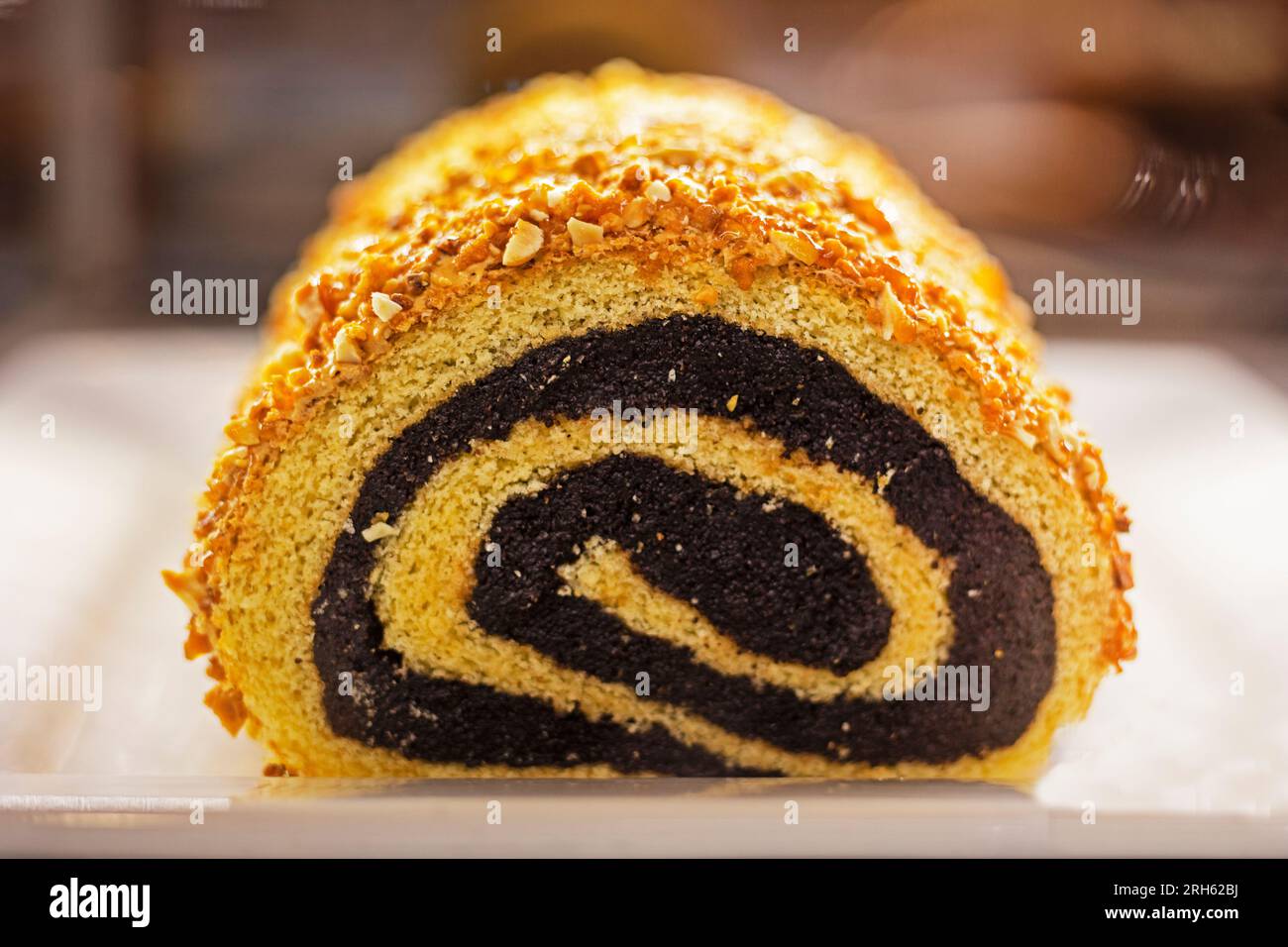 cut fresh piece of poppy seed roll. homemade baking Stock Photo - Alamy