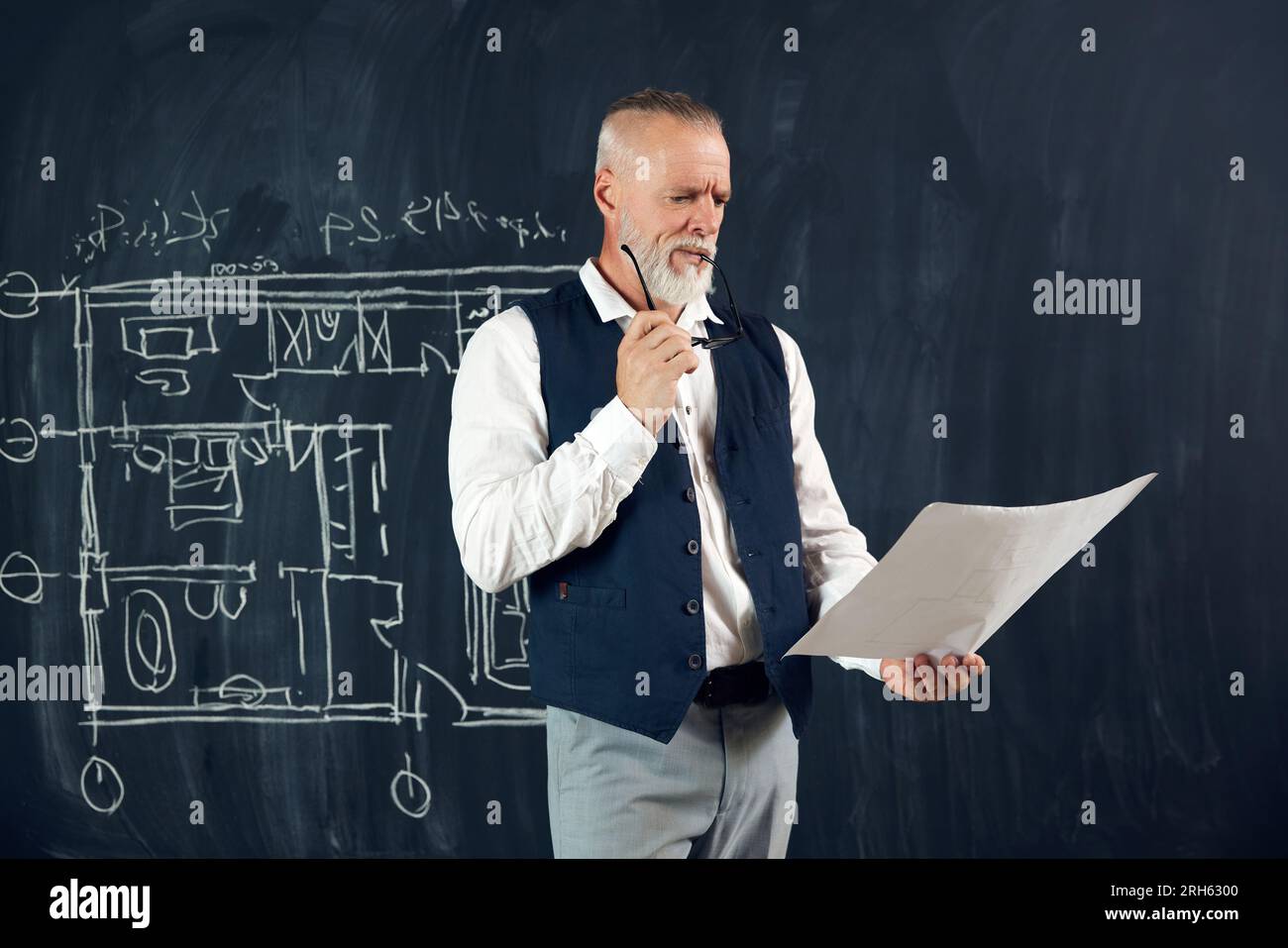 Senior stylish man, professional architect looking on sketches ...