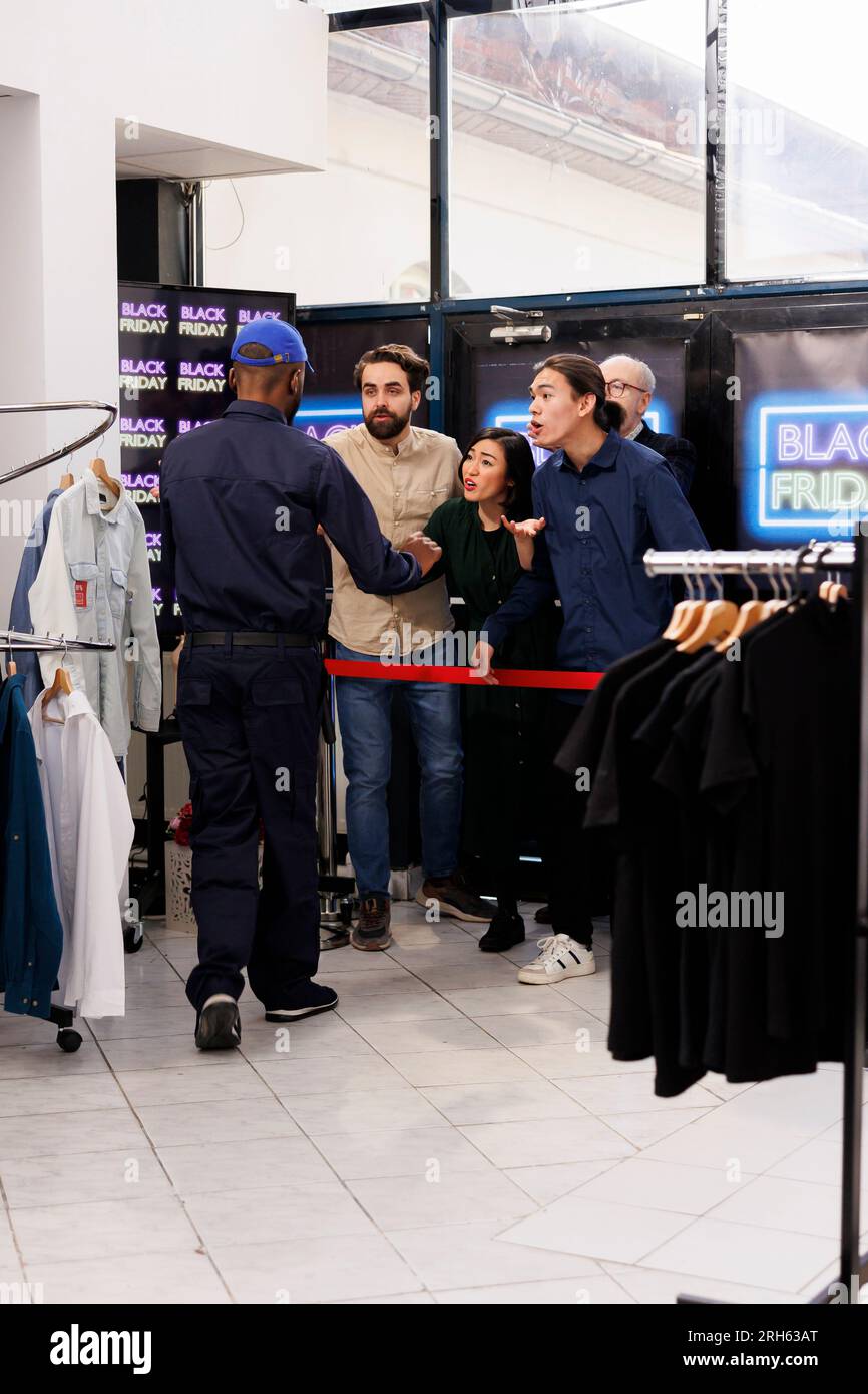 Eager emotional shoppers lined up outside of department store ...