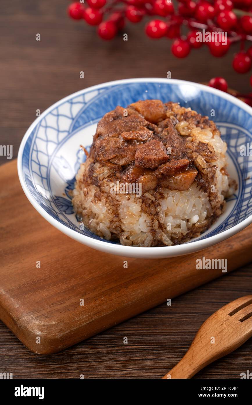 Migao, tube rice cake, rice pudding in a bowl topped with minced pork ...