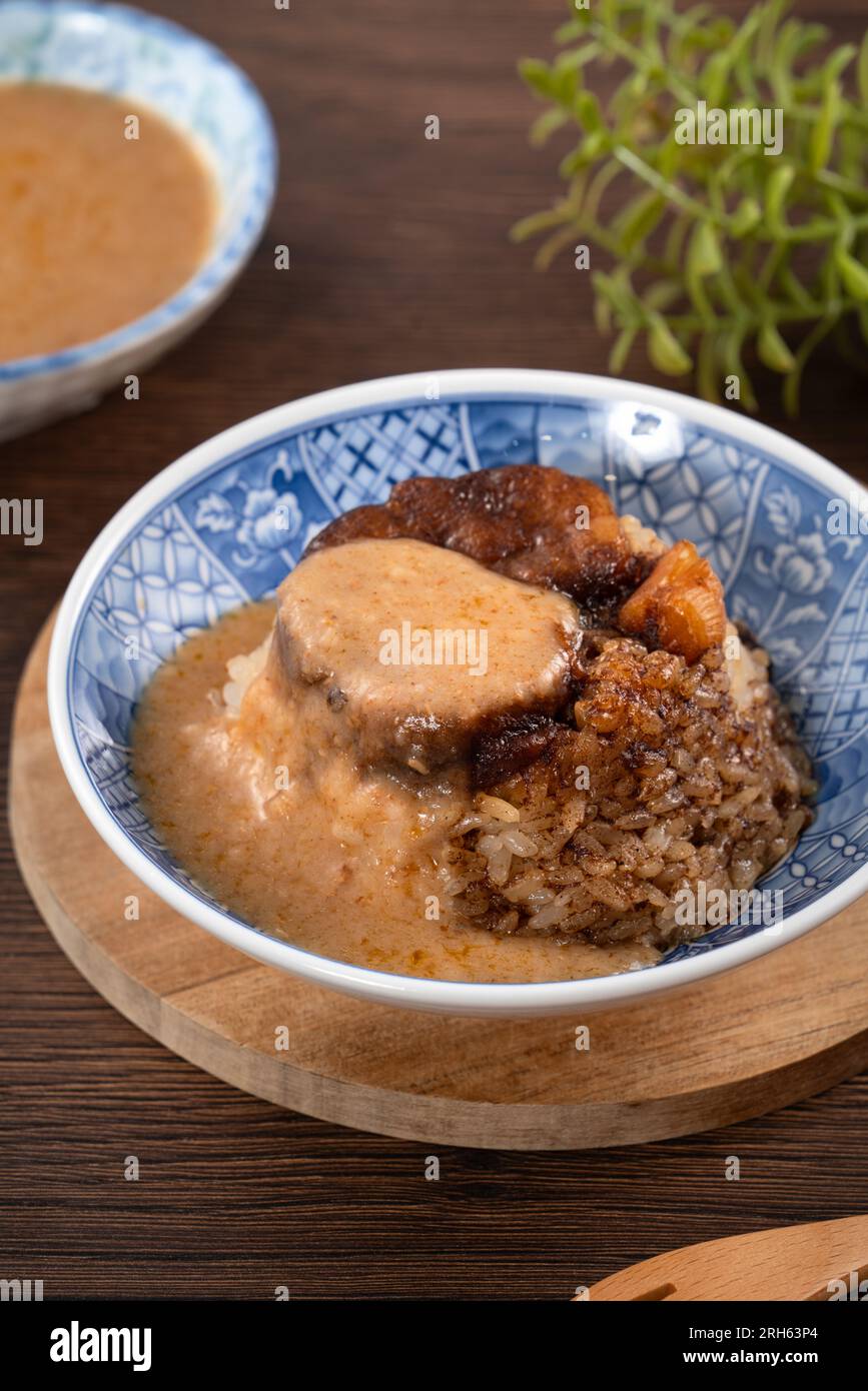 Migao, tube rice cake, rice pudding in a bowl topped with minced pork ...