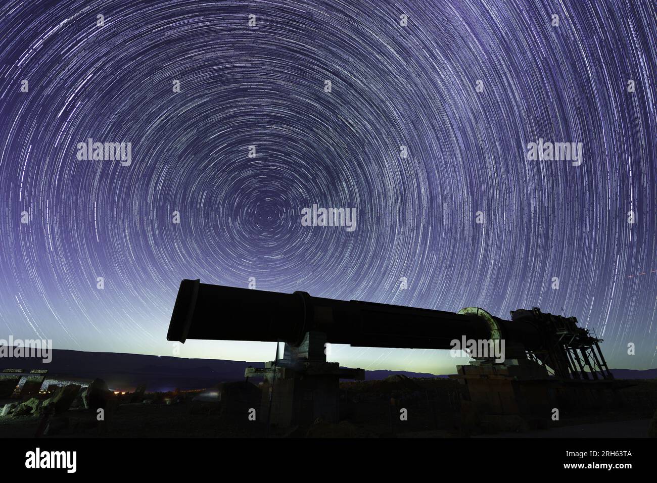 View of star trails and perseid meteors, over an old quarry oven, in ...