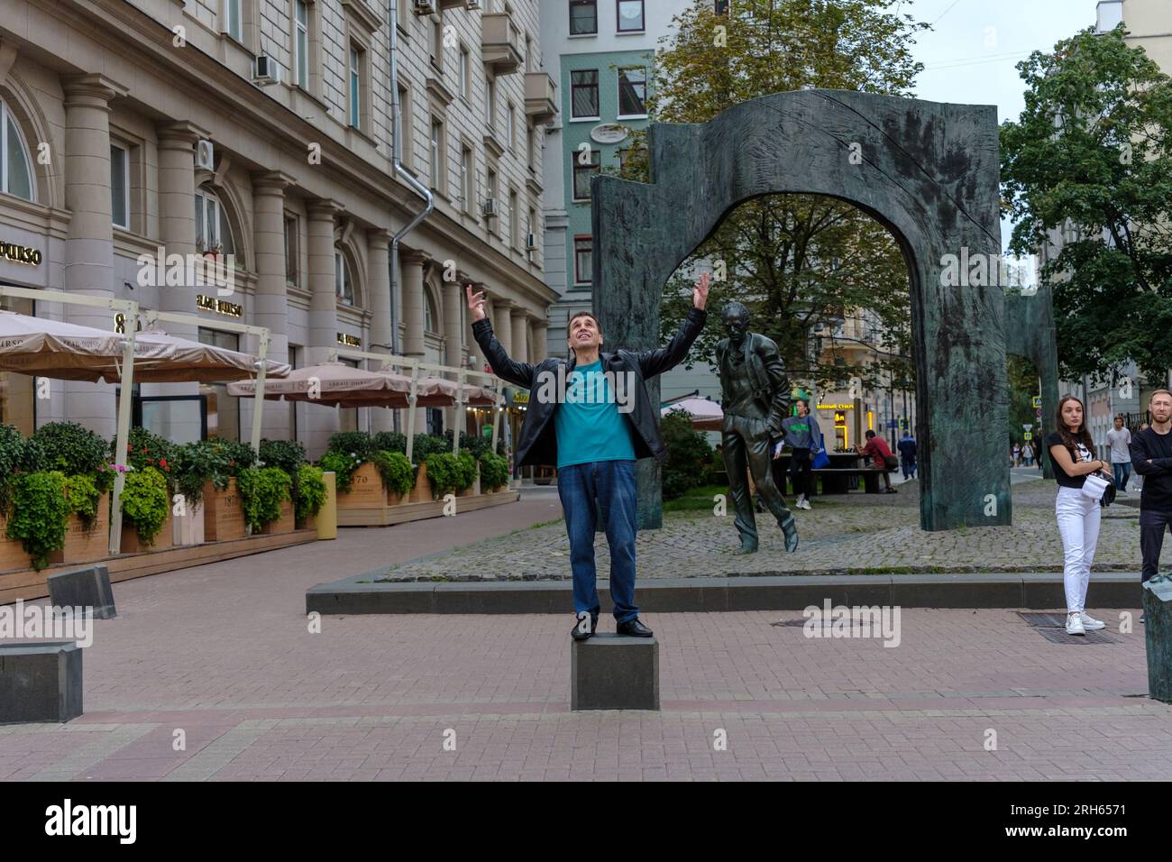 A man recites poetry on Stary Arbat street in front of the monument to ...